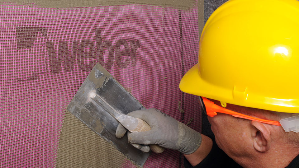 Insulating and rendering a timber framed construction